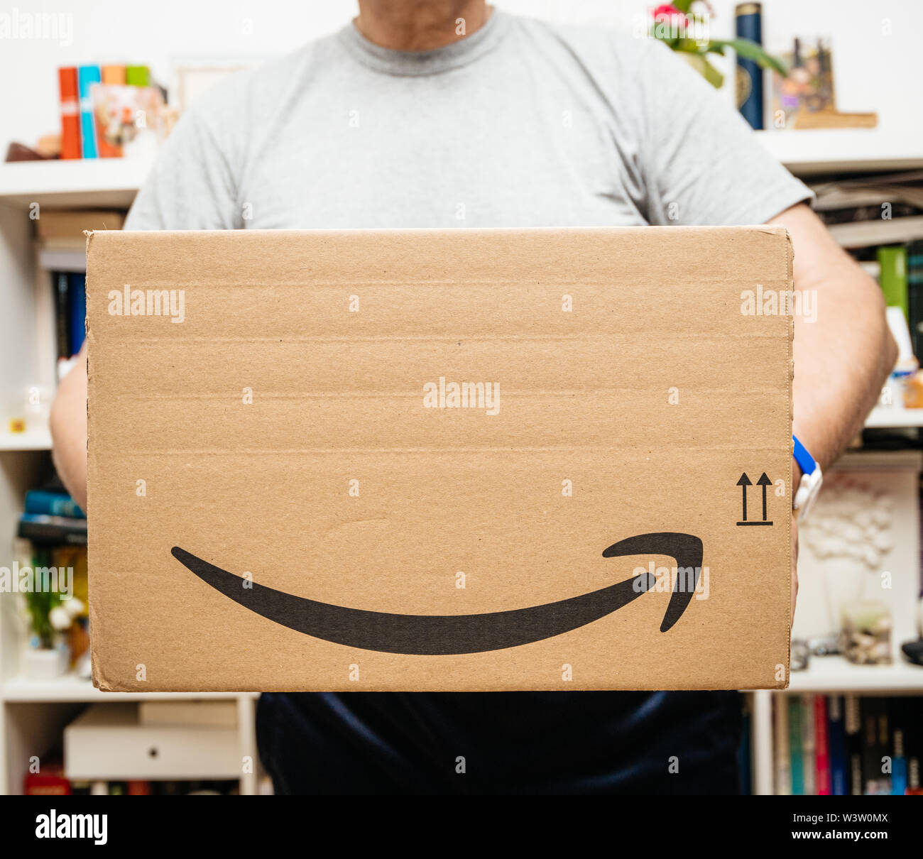 PARIS, FRANCE - JUL 12, 2108: Senior man holding Amazon Prime cardboard ...