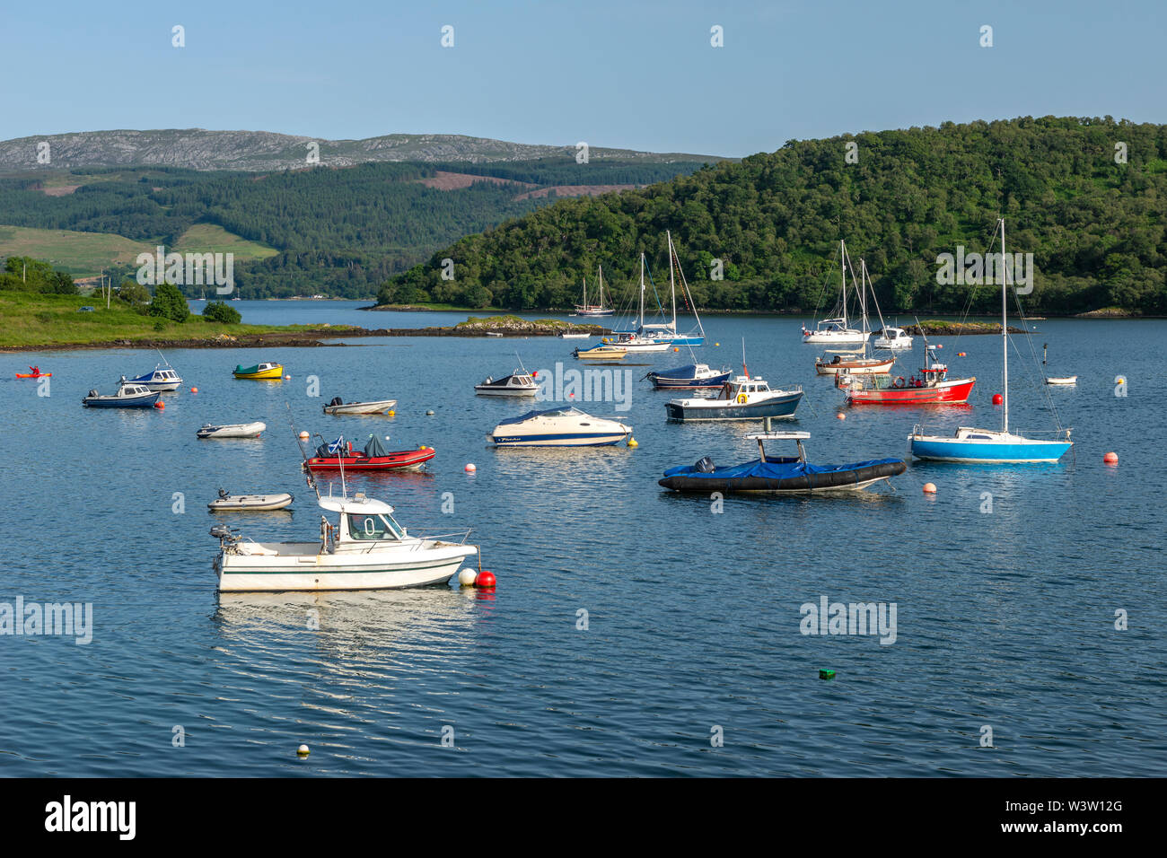 Boats at anchor in sheltered bay of Loch Sween at picturesque fishing ...