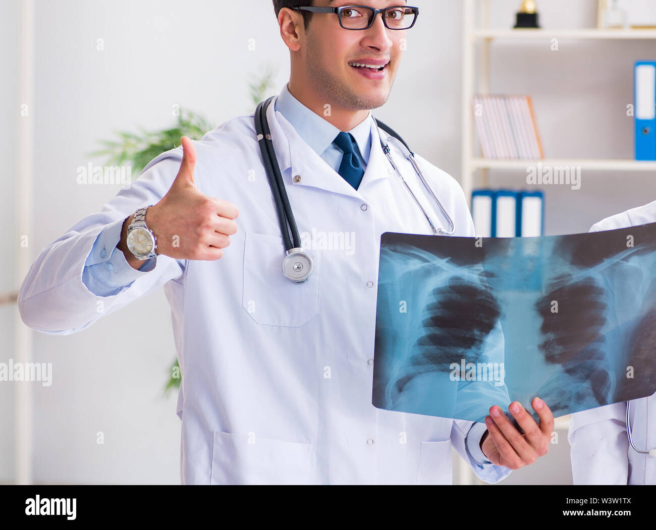 The two doctors examining x-ray images of patient for diagnosis Stock ...