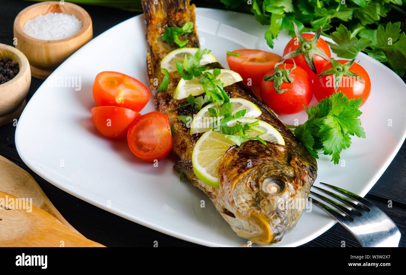 The fried fish served on the plate Stock Photo - Alamy