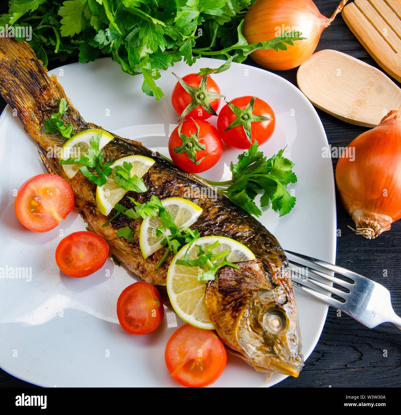 The fried fish served on the plate Stock Photo - Alamy