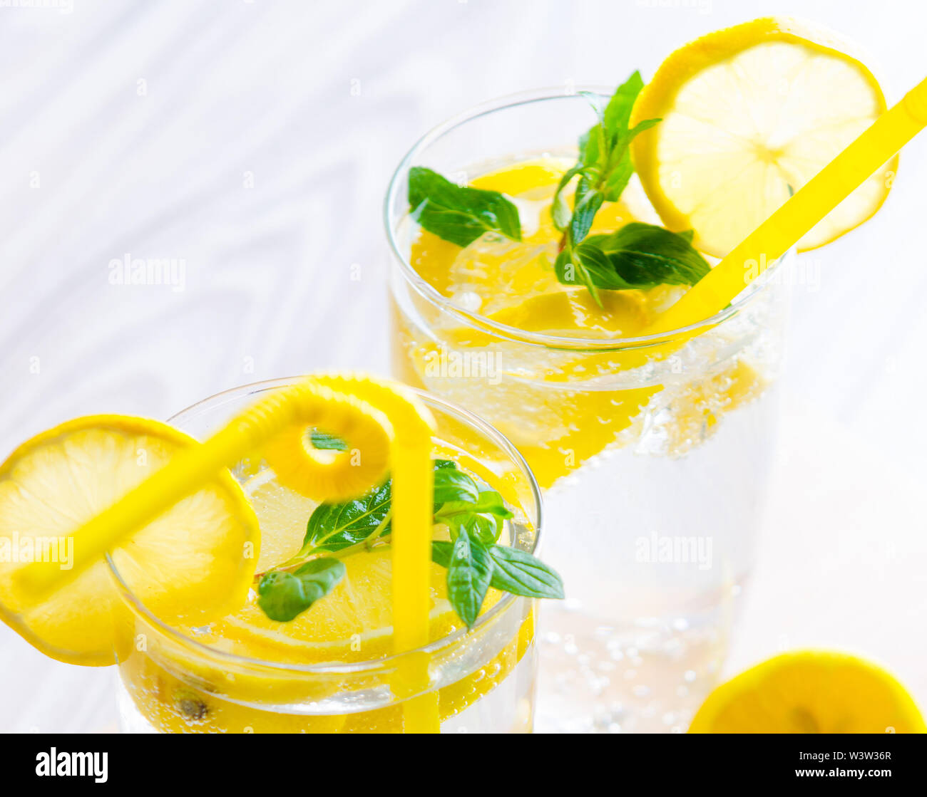 Glasss of mojito with lemon and drinking straw hi-res stock photography ...