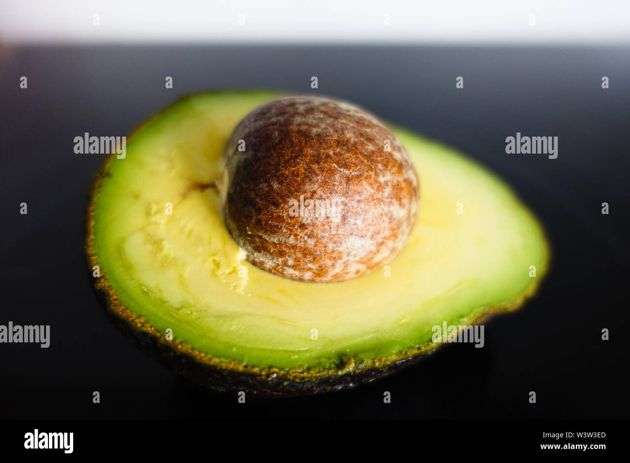 Close-up of the bone of an avocado, isolated Stock Photo - Alamy