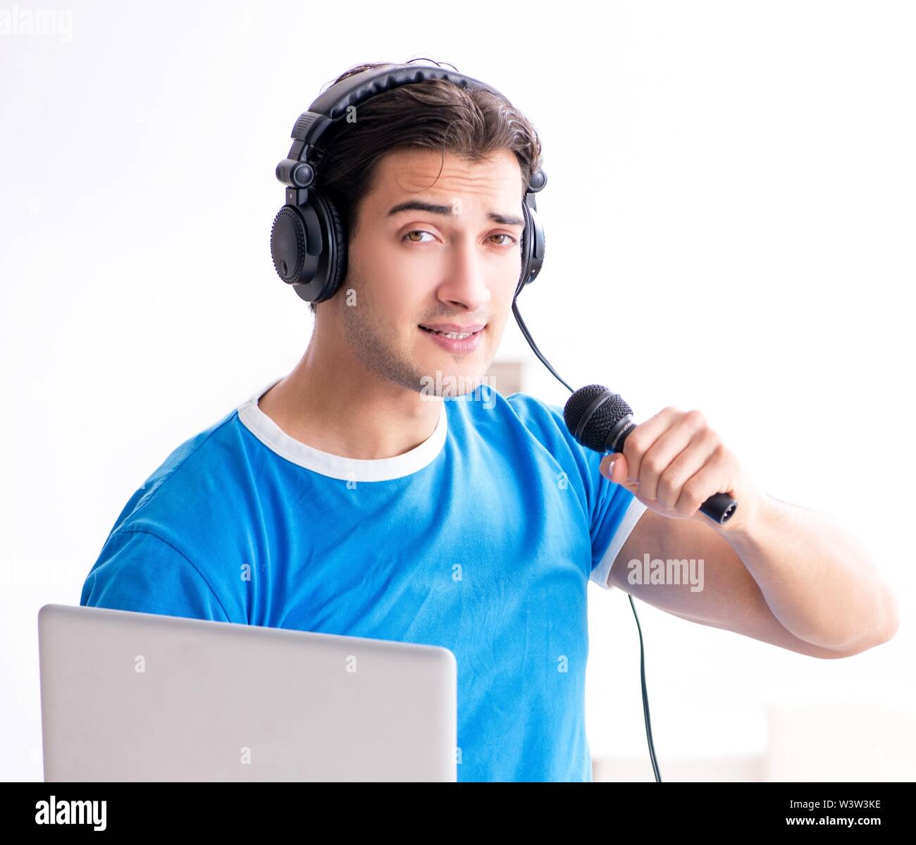 The young man singing at home karaoke Stock Photo - Alamy