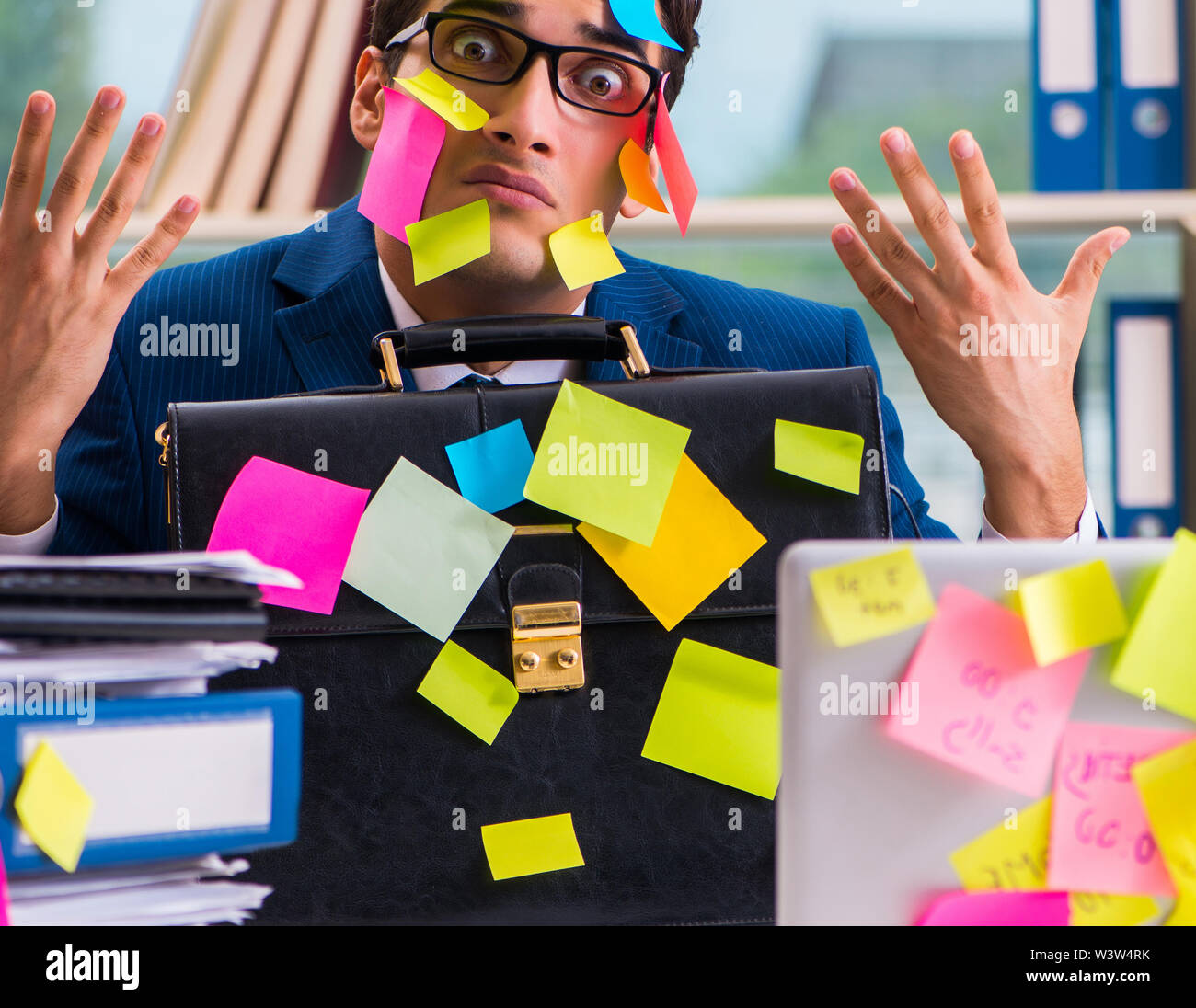 The businessman with reminder notes in multitasking concept Stock Photo ...