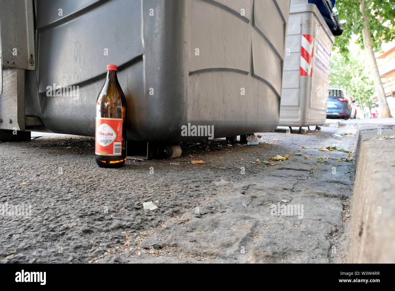 A one litre bottle of Alhmabra tradicional beer abandoned by the side ...