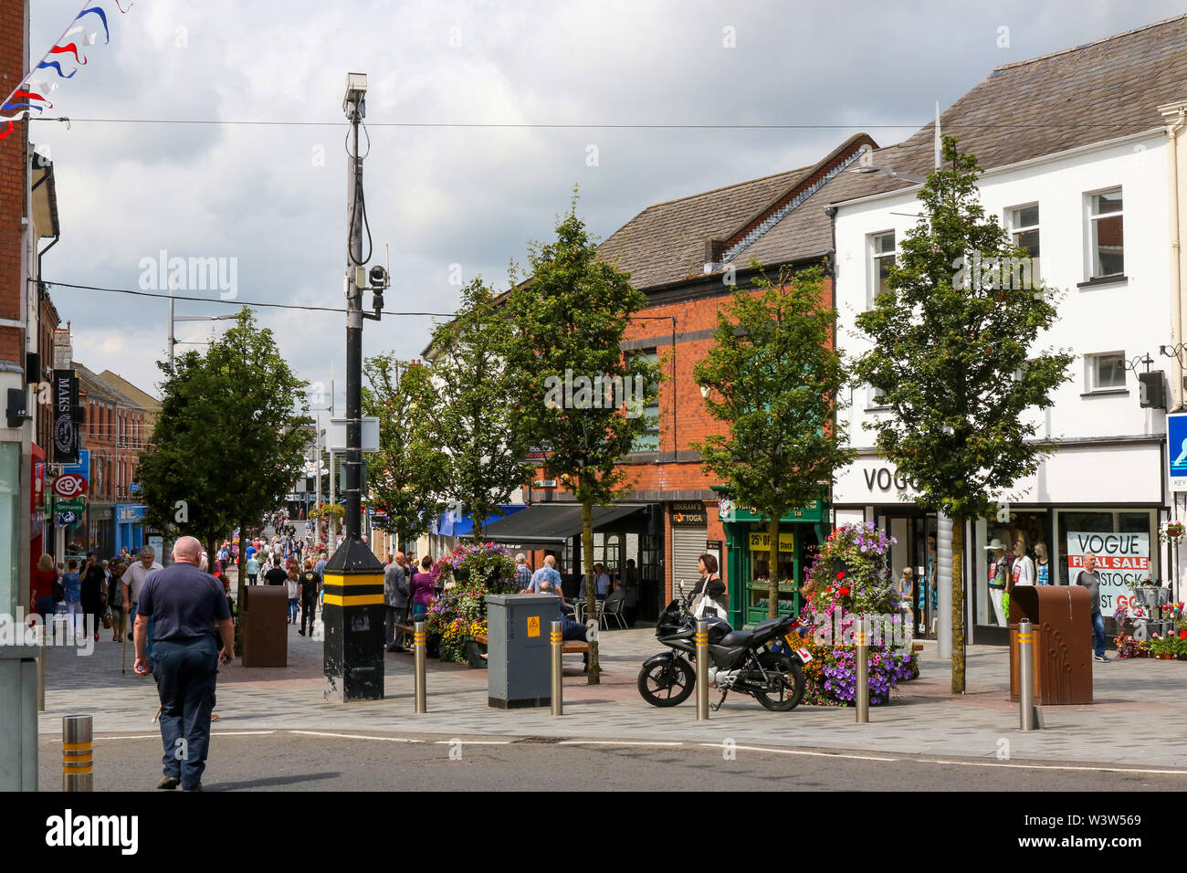 A main shopping street in Lisburn filled with shoppers and pedestrians ...