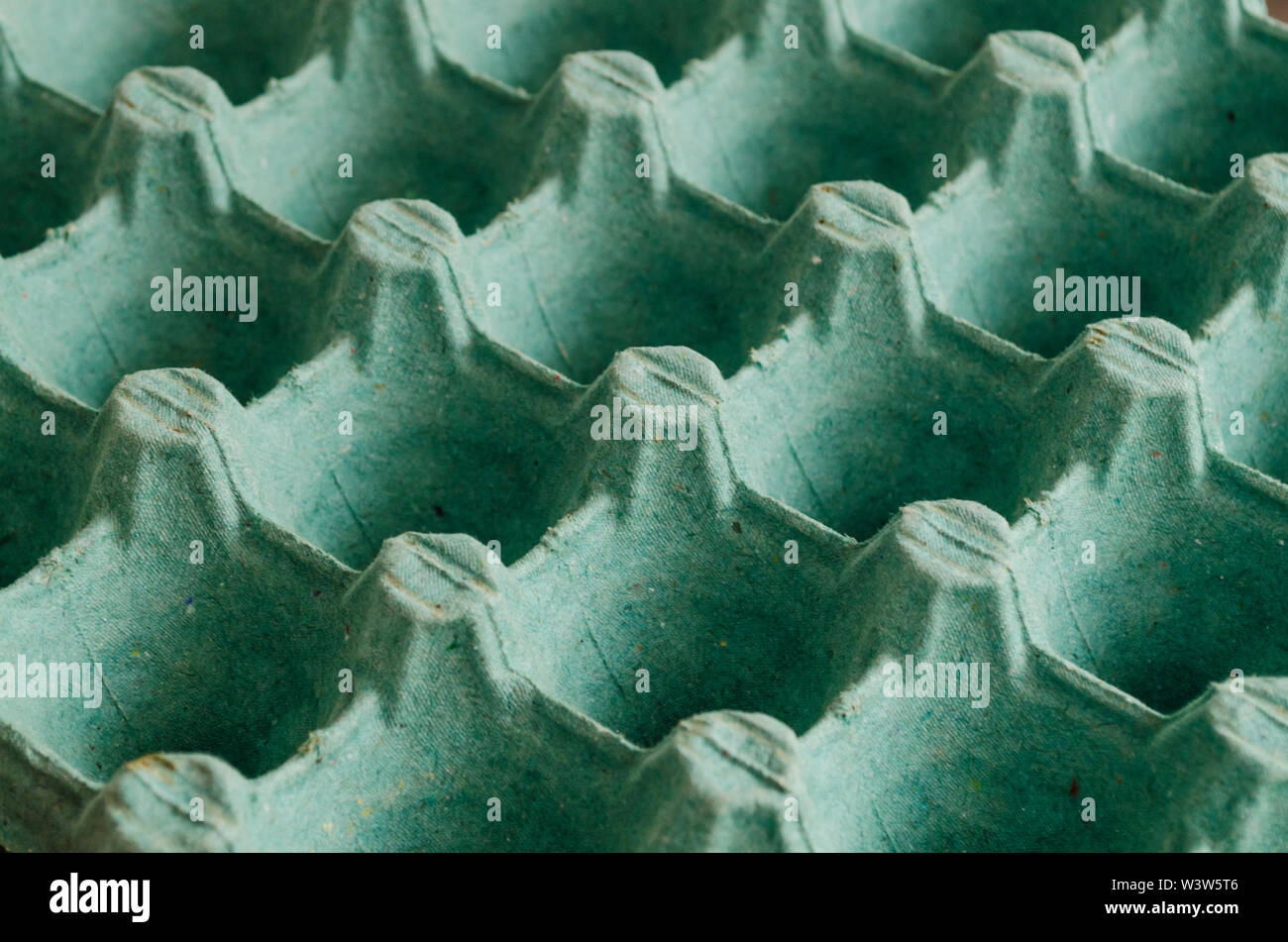 open empty egg green packaging forming a pattern with holes and ...