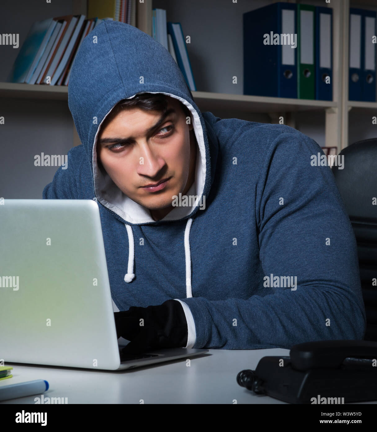 The young hacker hacking into computer at night Stock Photo - Alamy