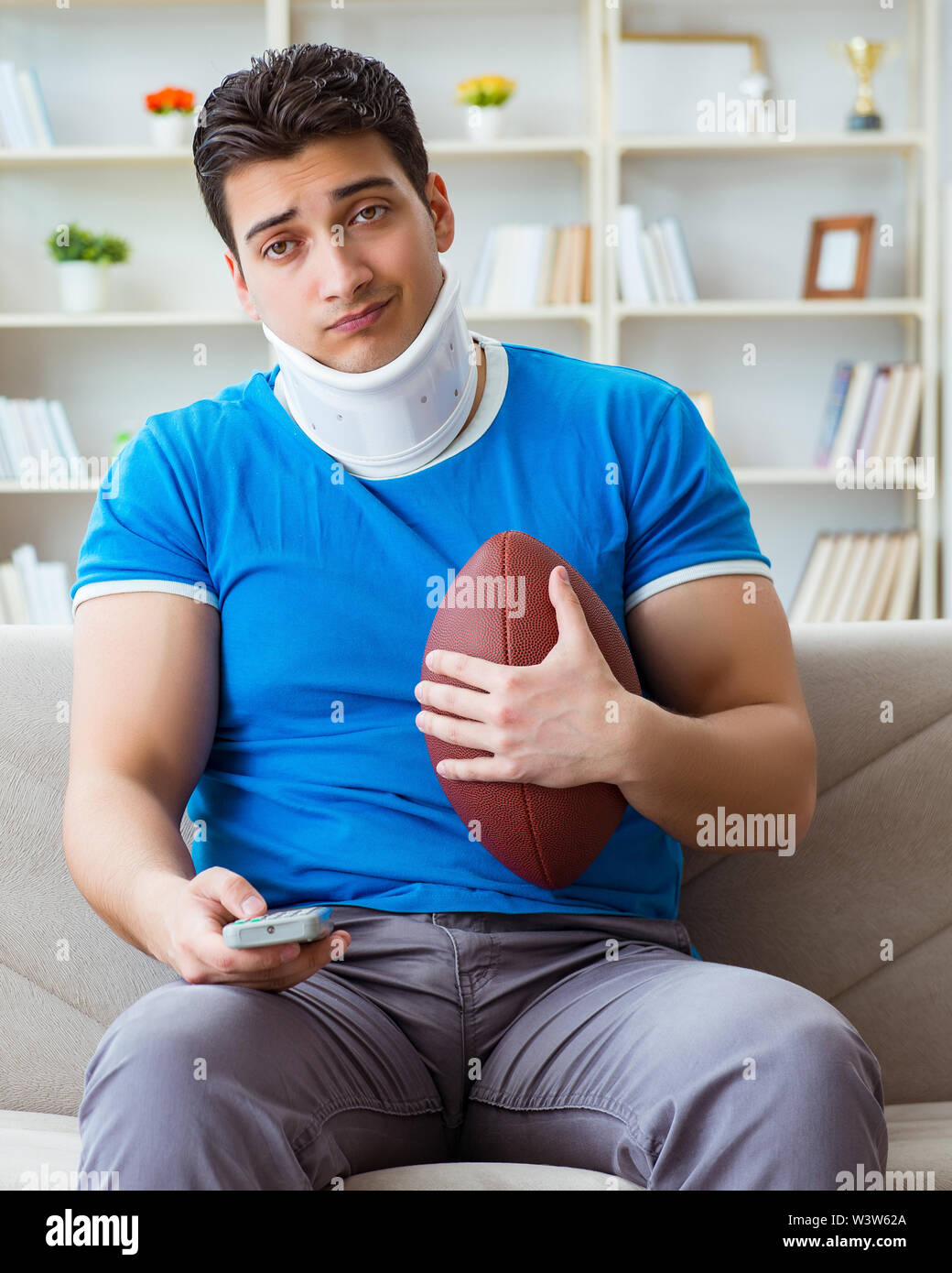 The man with neck injury watching american football at home Stock Photo ...