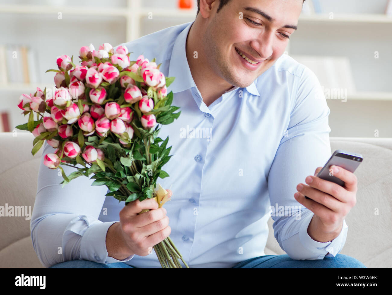 The young man chatting with his sweetheart over mobile phone Stock ...