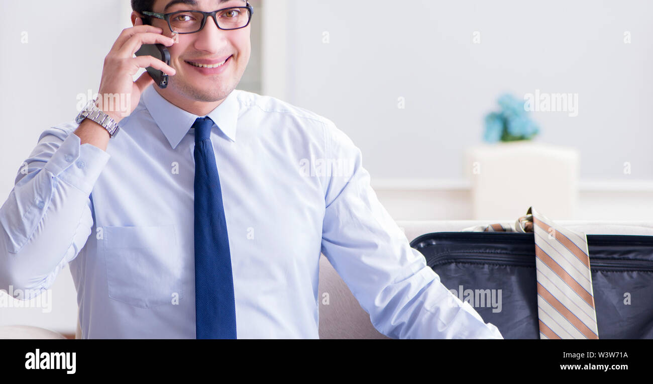 The businessman preparing packing for business trip Stock Photo - Alamy