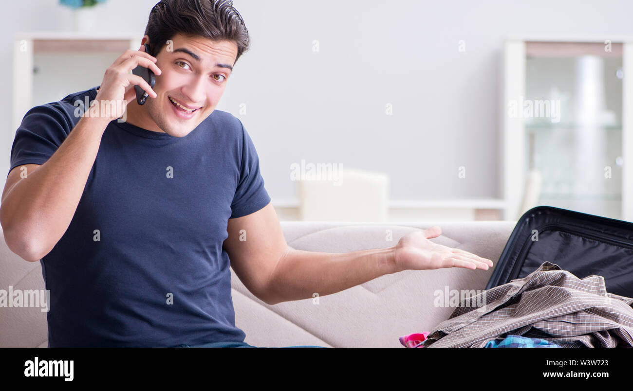 The young man preparing packing for summer vacation Stock Photo - Alamy