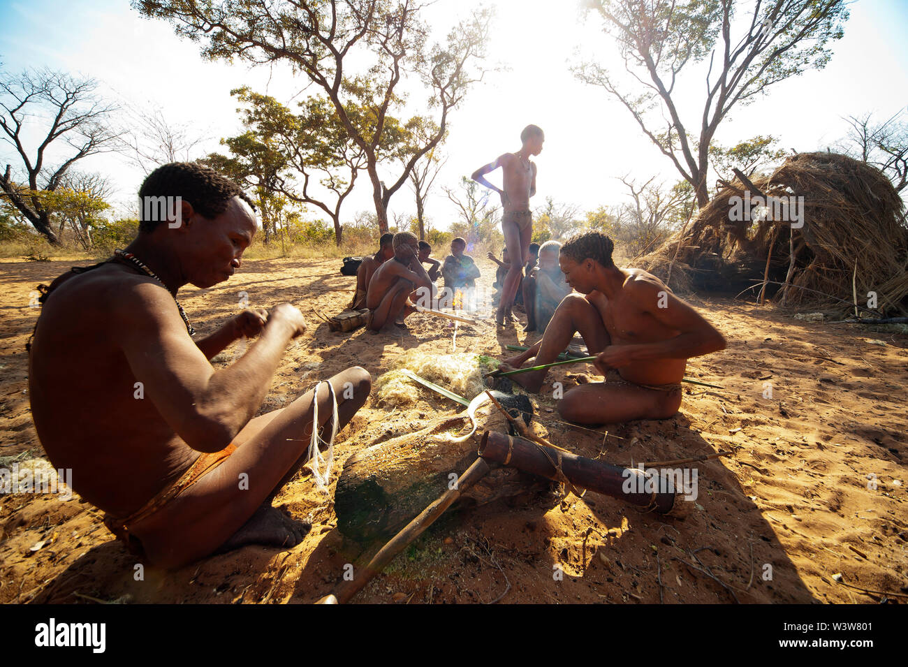 Ju/'Hoansi or San bushmen performing different tasks at their Grashoek ...