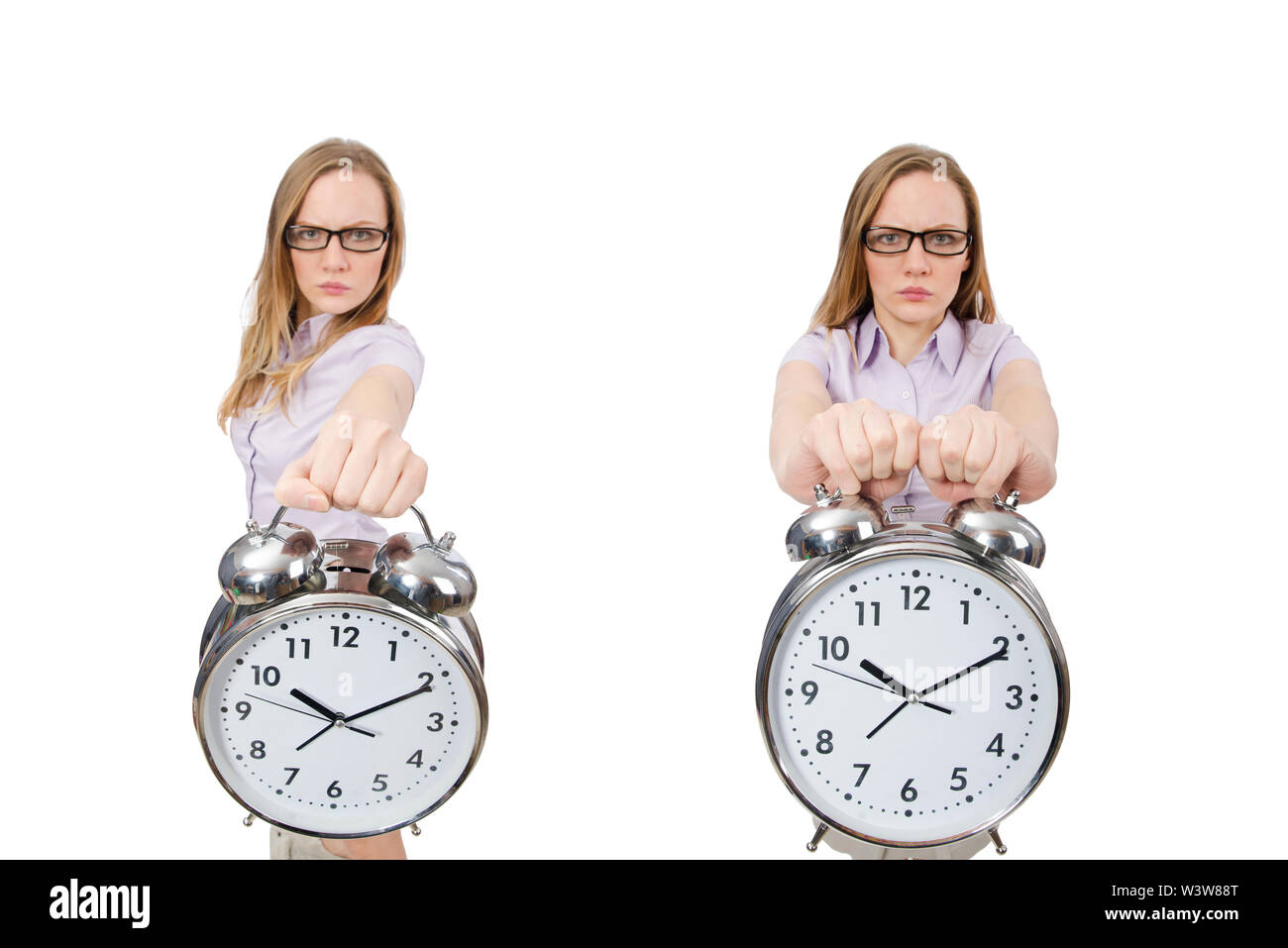 The young employee holding alarm clock isolated on white Stock Photo ...