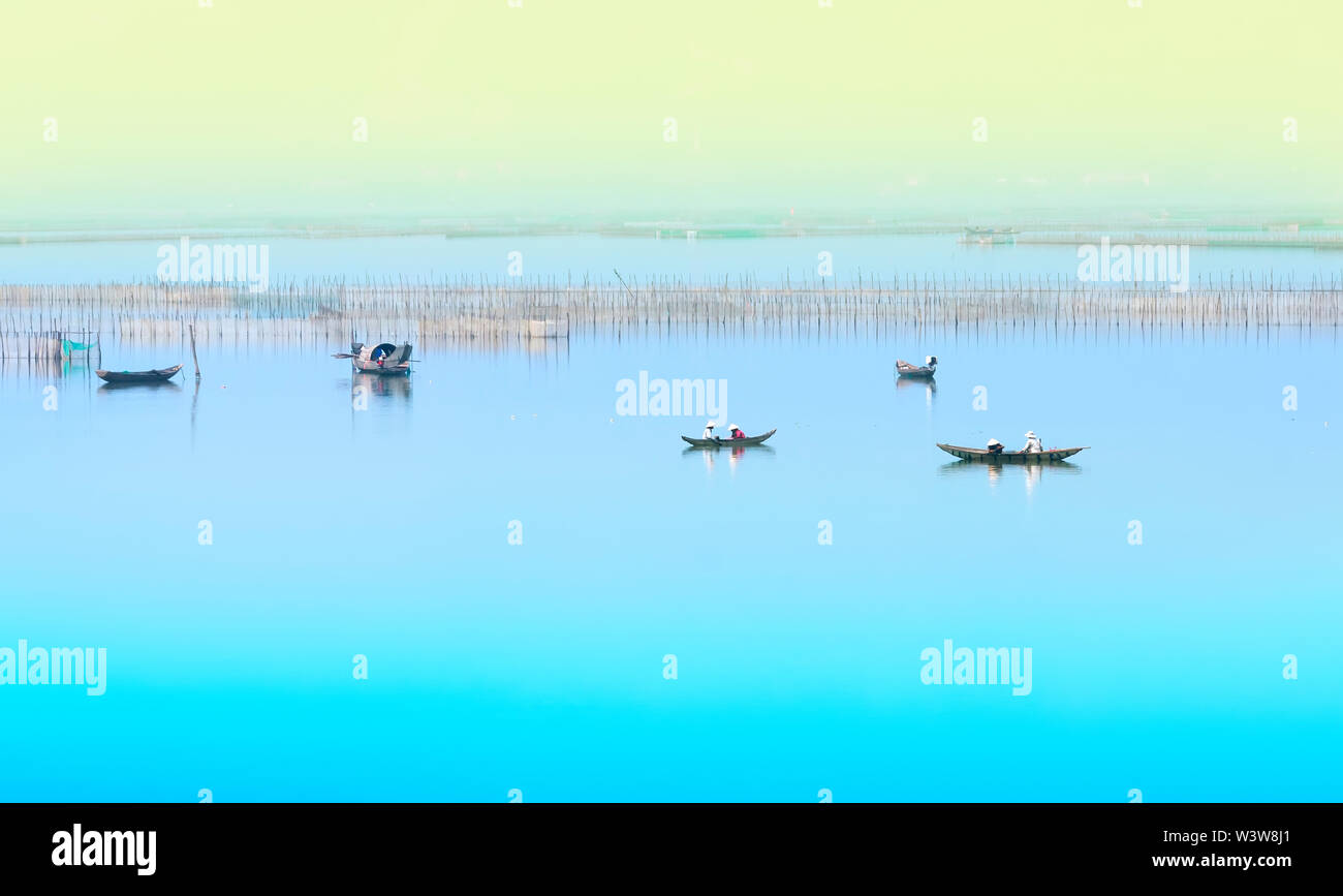 Small boats of fishermen move fishing in lagoon one of the largest ...