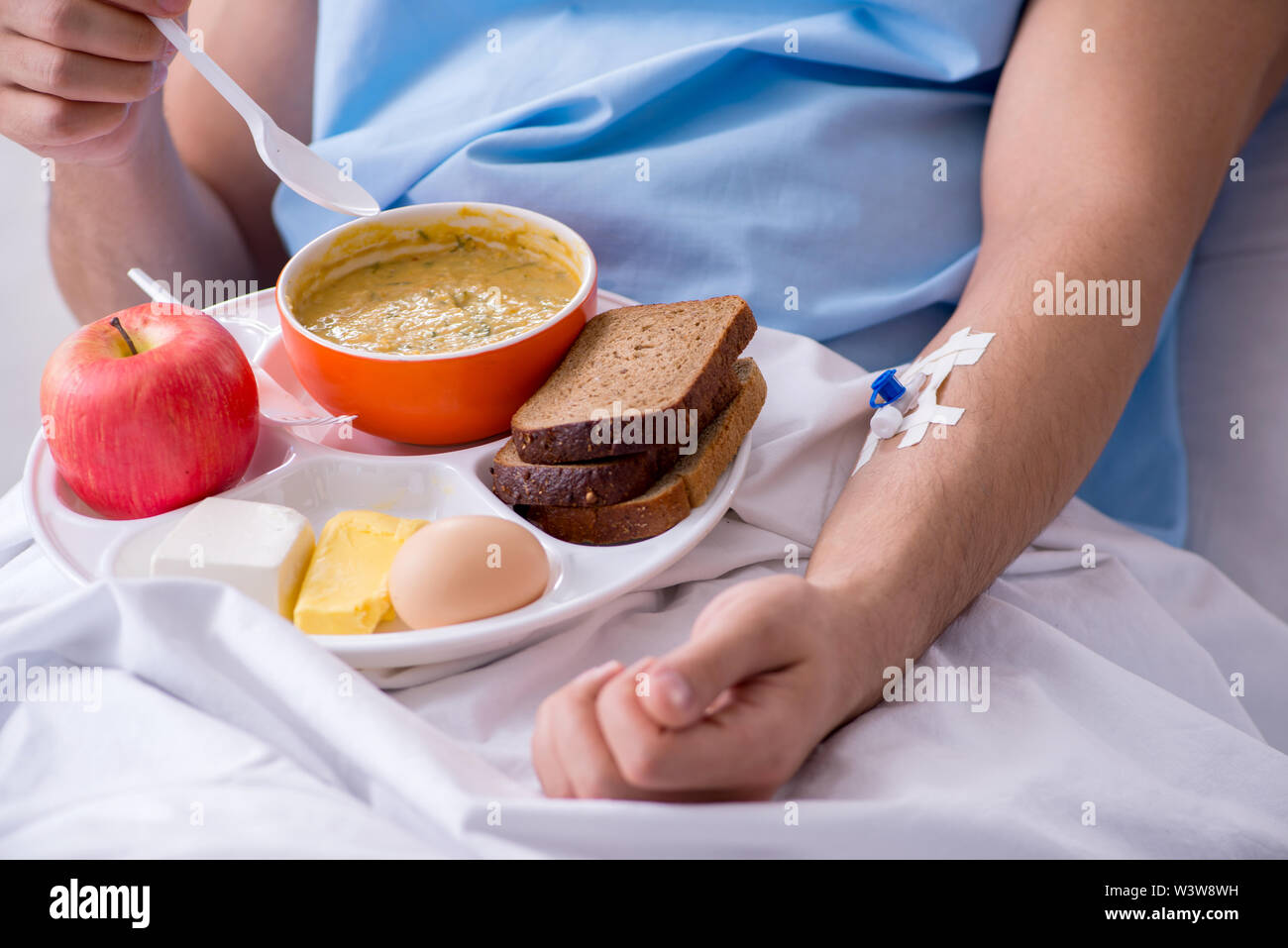 The male patient eating food in the hospital Stock Photo - Alamy