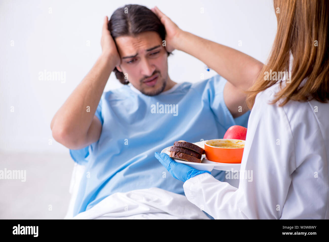 The male patient eating food in the hospital Stock Photo - Alamy