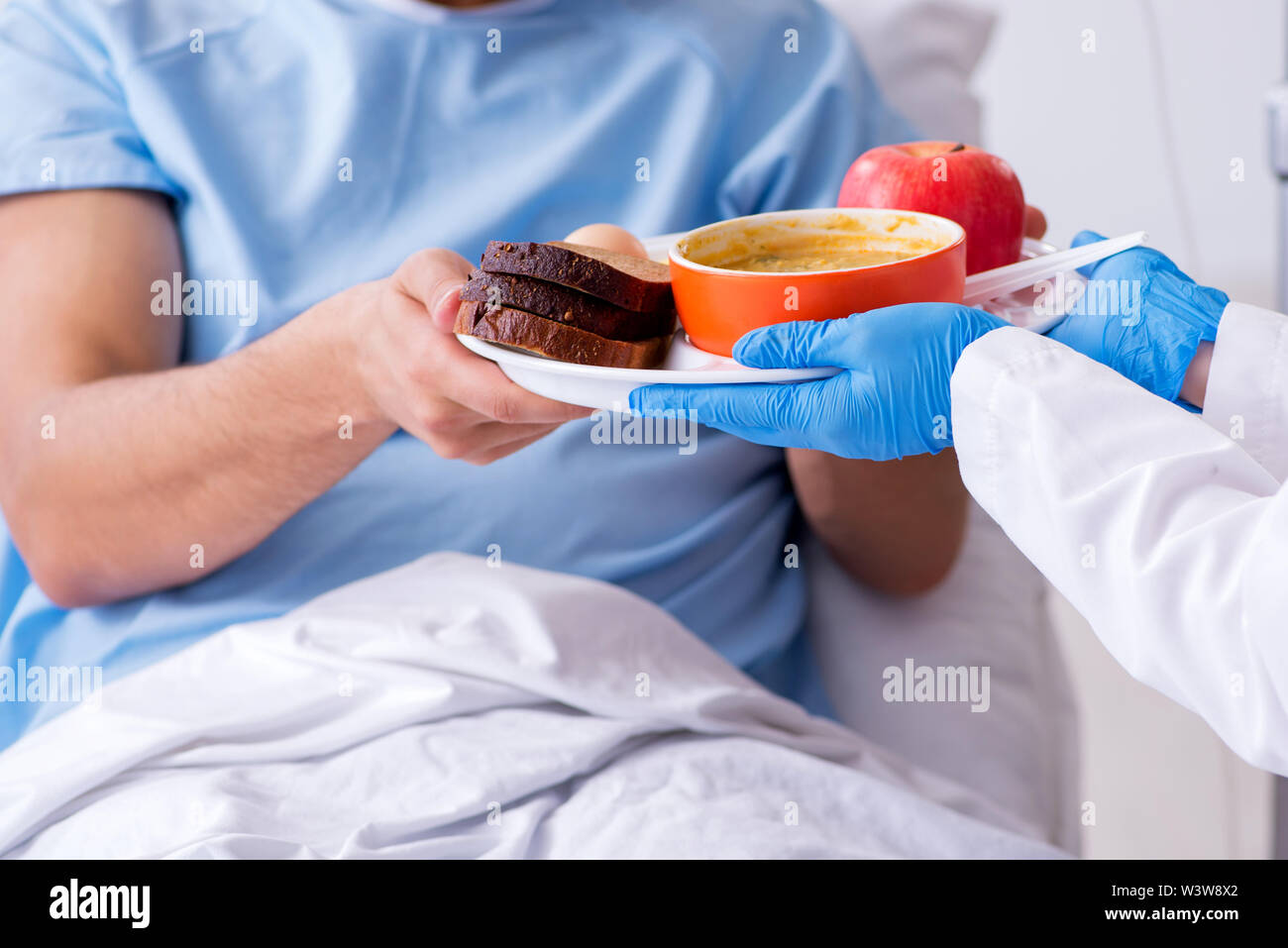 The male patient eating food in the hospital Stock Photo - Alamy