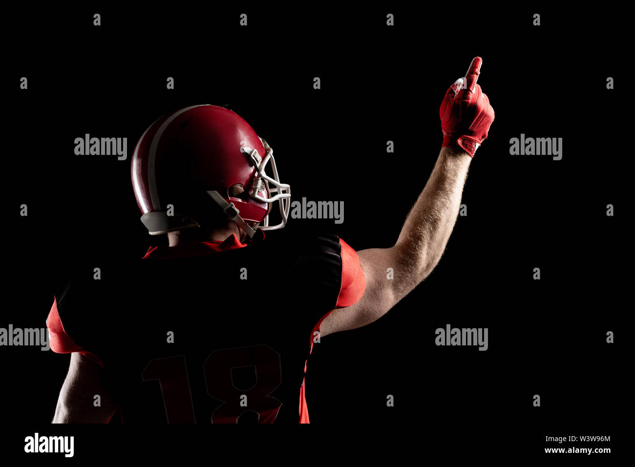 American football player in helmet pointing upwards Stock Photo - Alamy