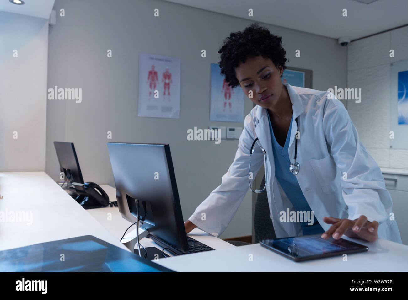 Doctor working using computer african hi-res stock photography and ...
