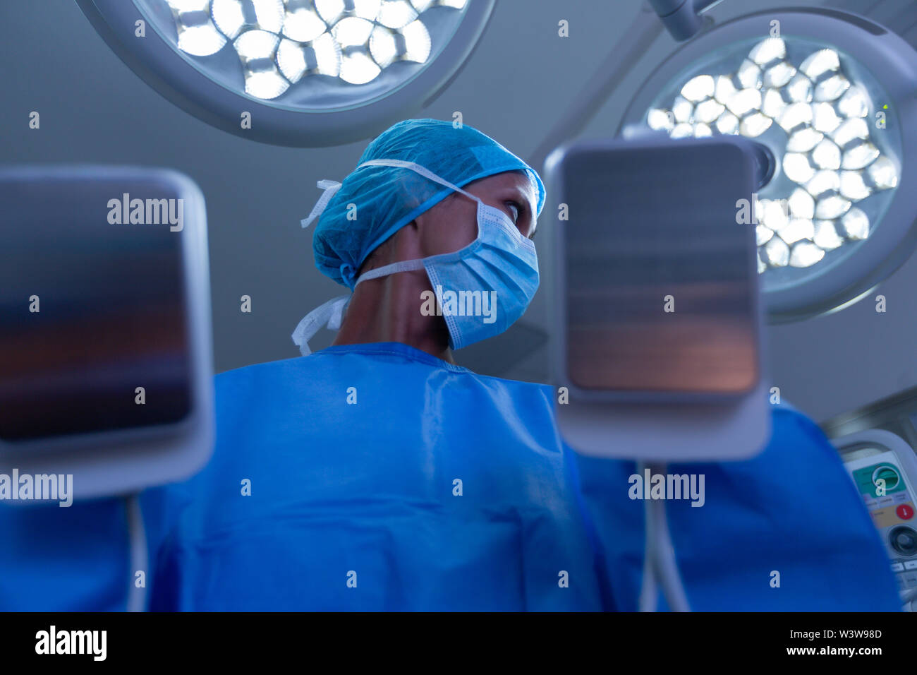 Female surgeon using defibrillator in operating room of hospital Stock ...