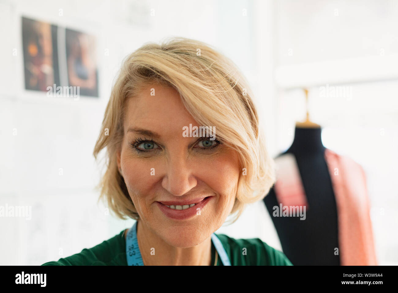 Happy female fashion designer smiling in the design studio Stock Photo ...