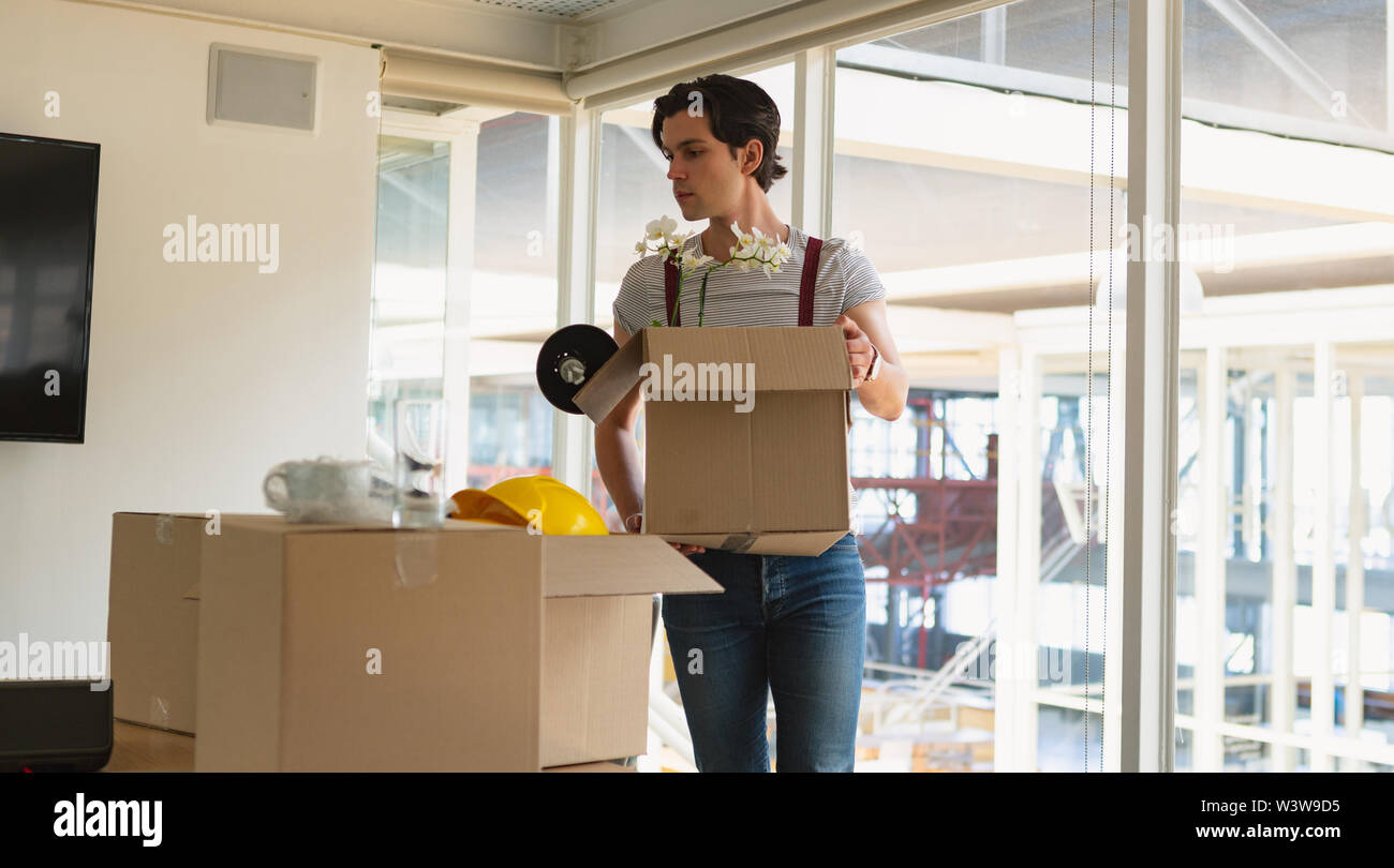Male executive holding a cardboard box in the conference room Stock ...