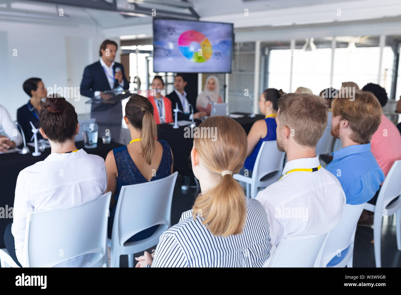Audience listening male speaker in a business conference Stock Photo ...