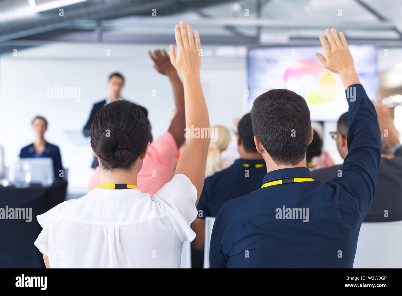 Audience raising their hands in a business conference Stock Photo - Alamy