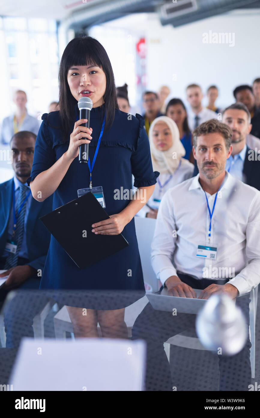 Business woman asking question in business seminar Stock Photo - Alamy