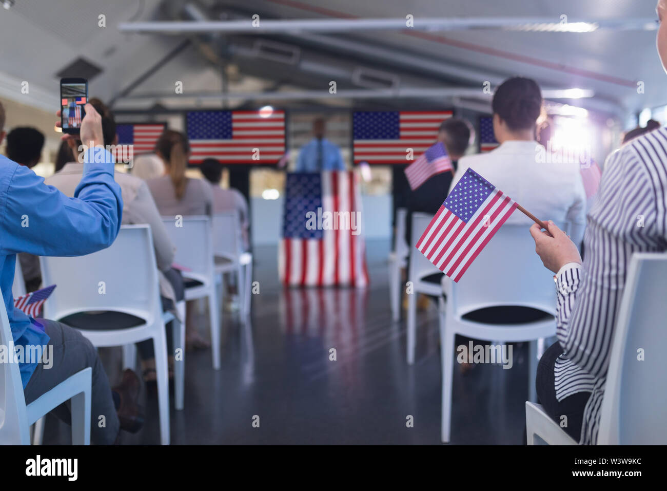 Business people waving an American flag in business seminar Stock Photo ...