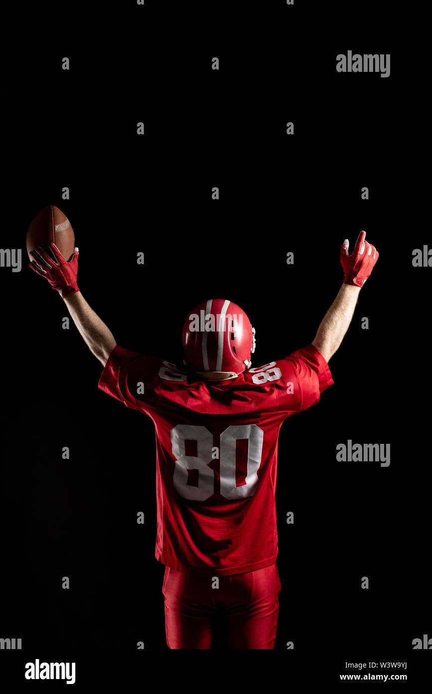 American football player cheering with arms up Stock Photo - Alamy