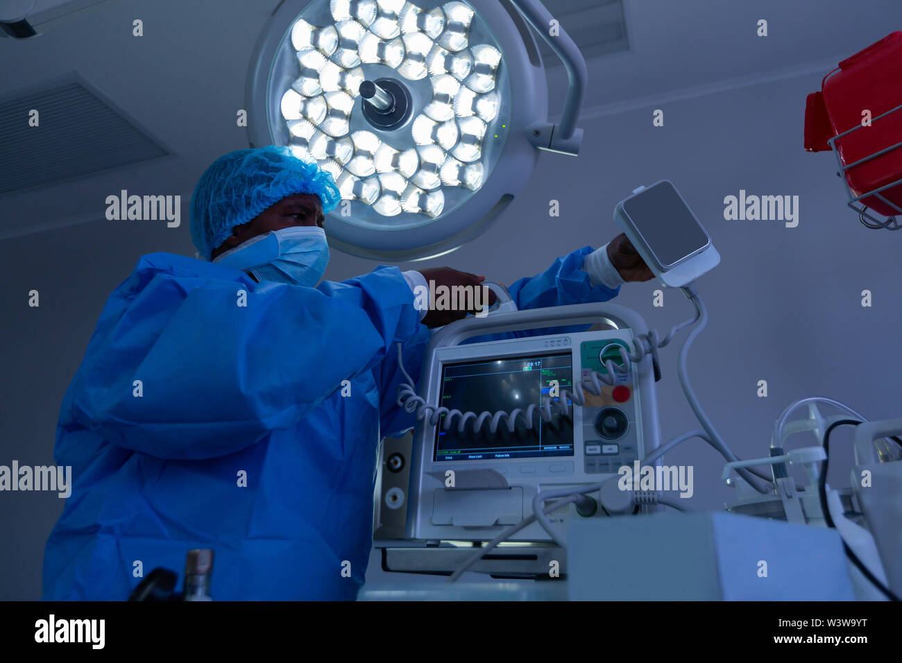 Male surgeon holding defibrillator in operating room of hospital Stock ...