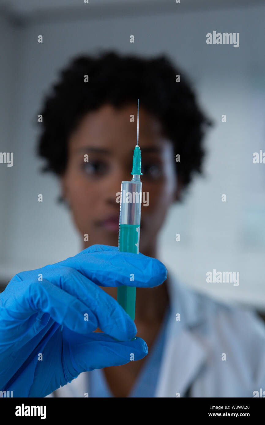 Female doctor holding syringe with needle at the hospital Stock Photo ...