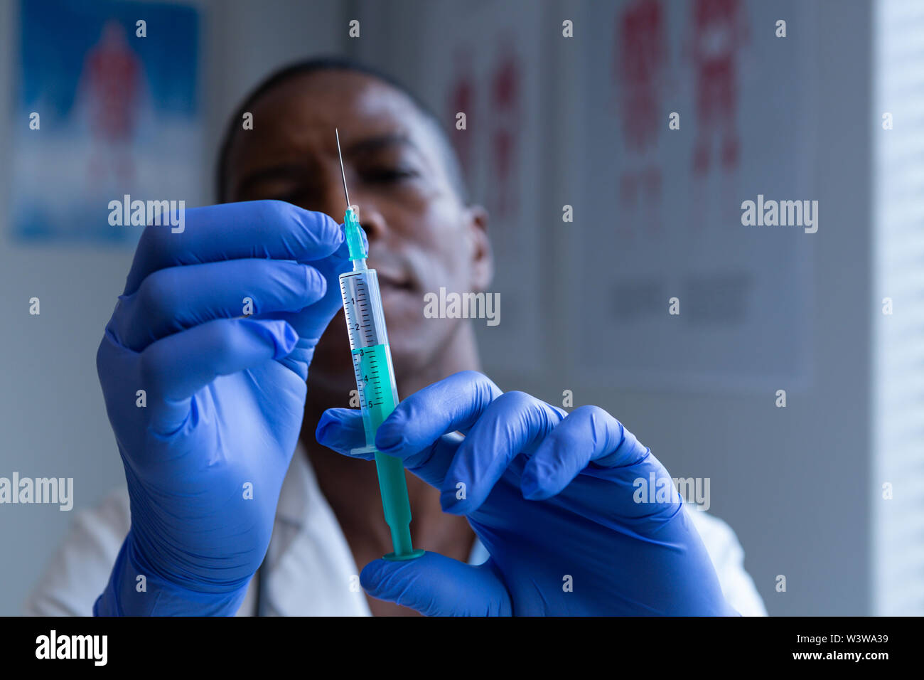 Male doctor holding syringe with injection in the hospital Stock Photo ...