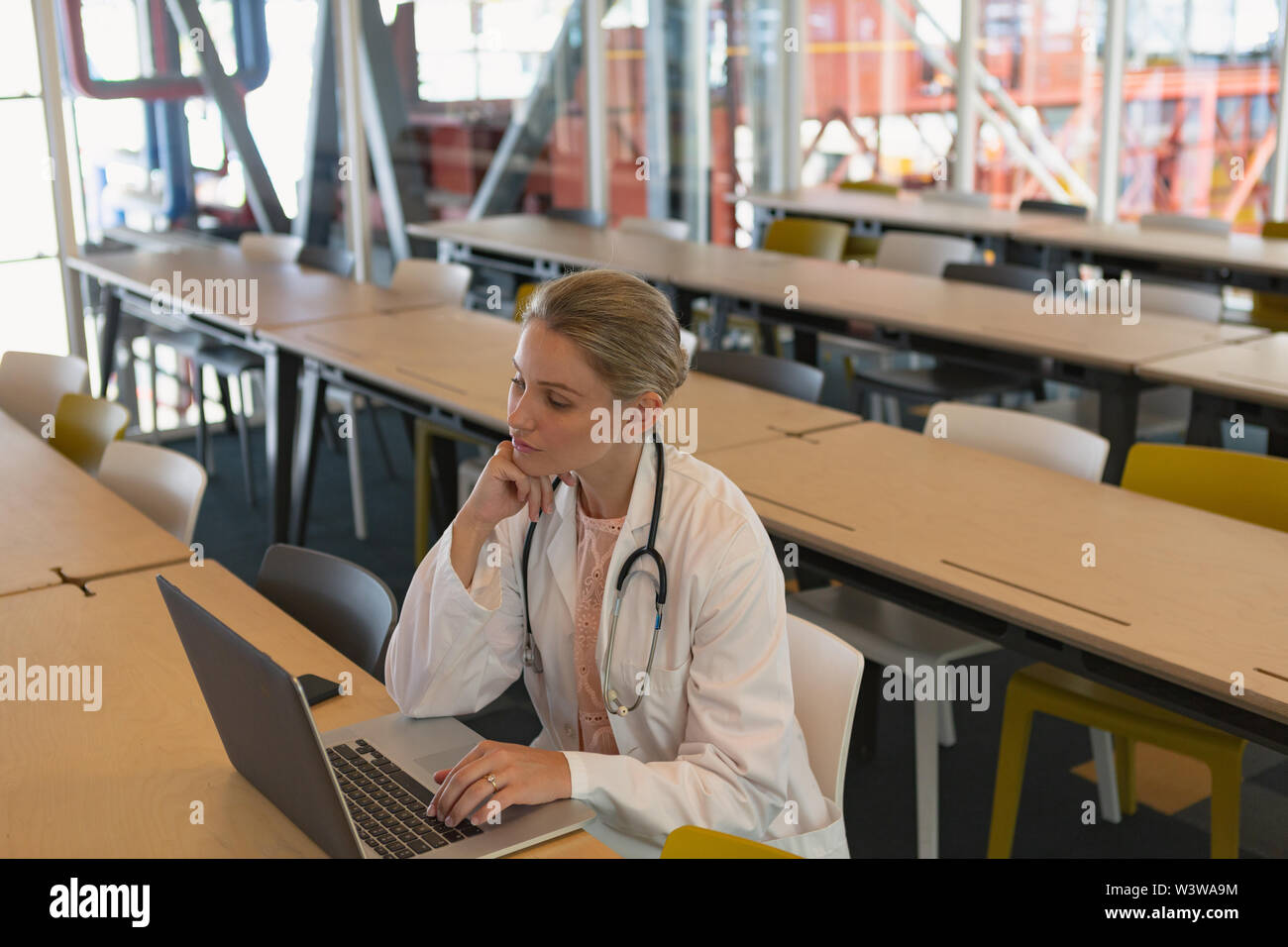 Female doctor using laptop in the medical seminar Stock Photo - Alamy