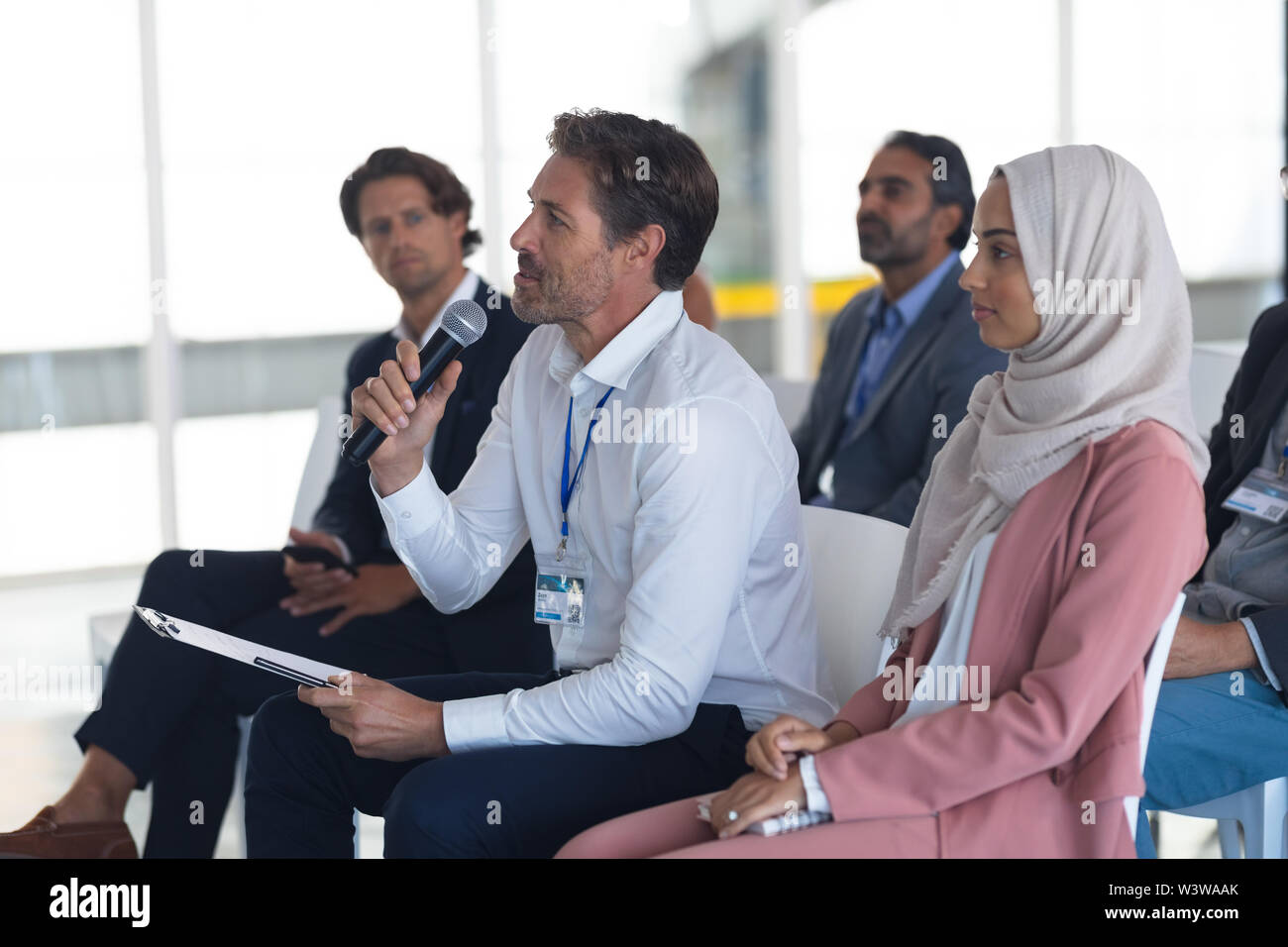 Businessman asking question during seminar Stock Photo - Alamy