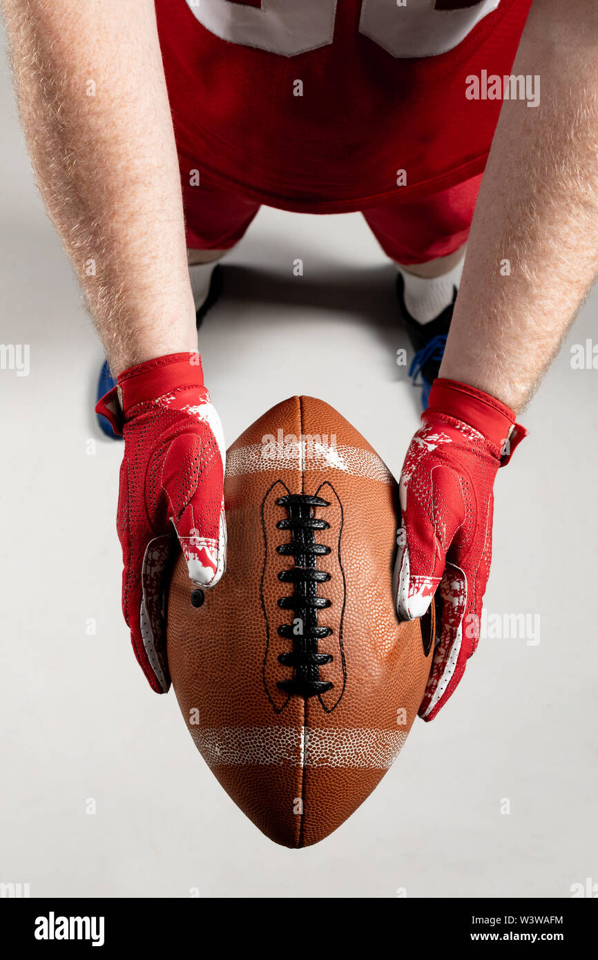 American football player standing with rugby ball Stock Photo - Alamy
