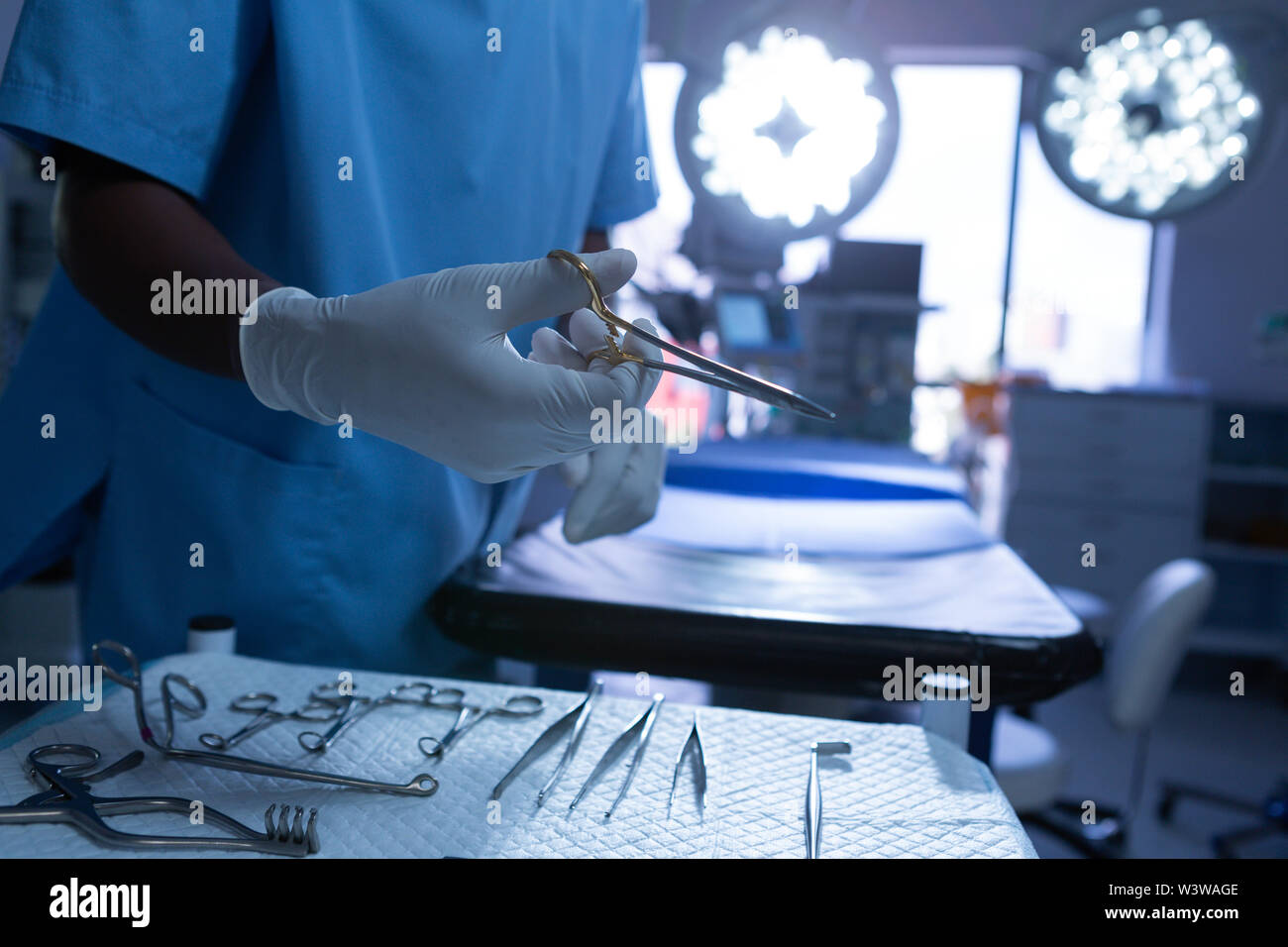 Surgeon holding surgical scissor in operating room of hospital Stock ...