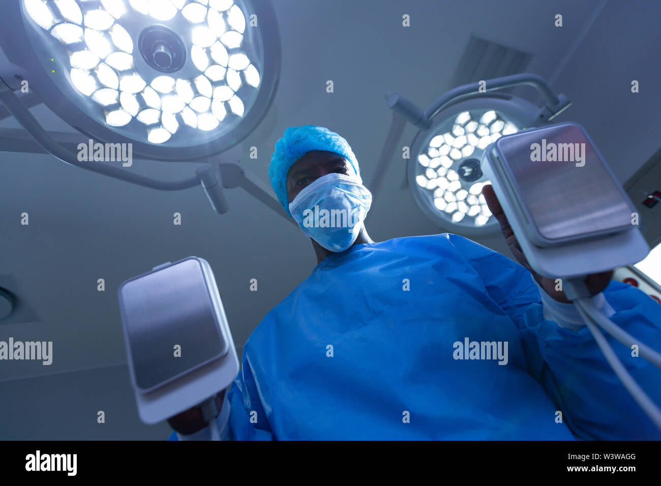 Male surgeon using defibrillator in operating room of hospital Stock ...