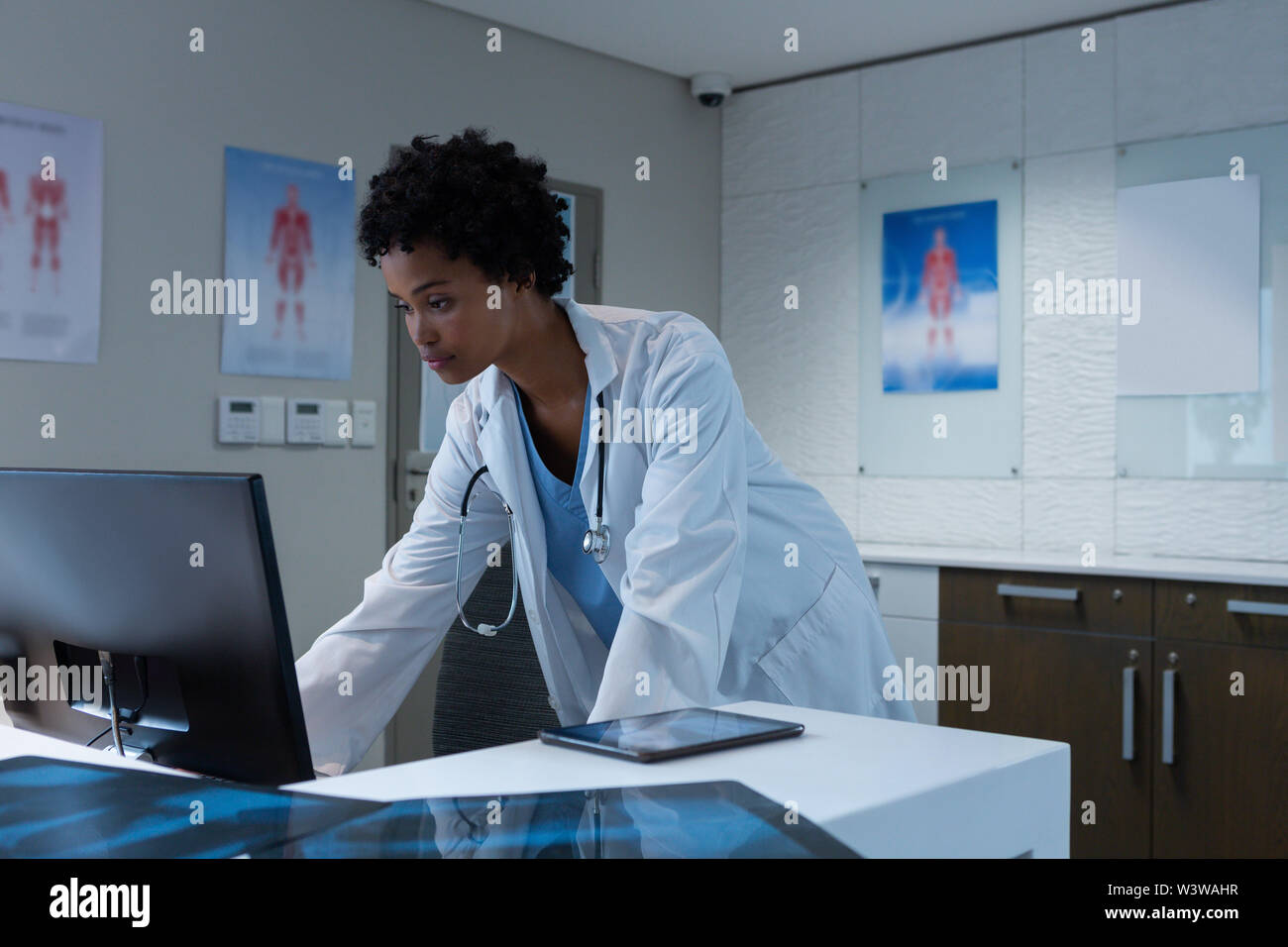 Female doctor working on computer at desk in the hospital Stock Photo ...