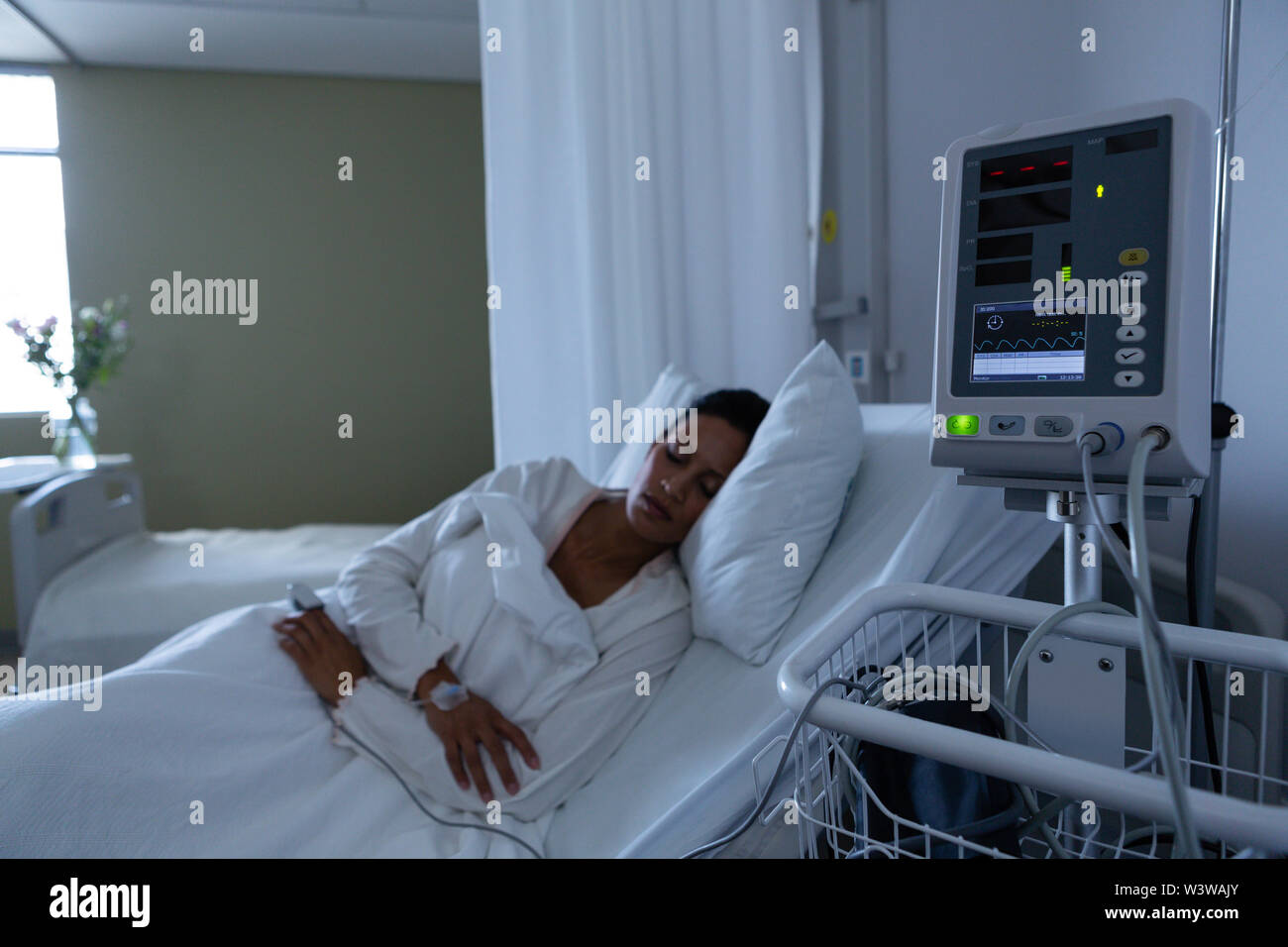 Female patient sleeping on bed at hospital Stock Photo - Alamy