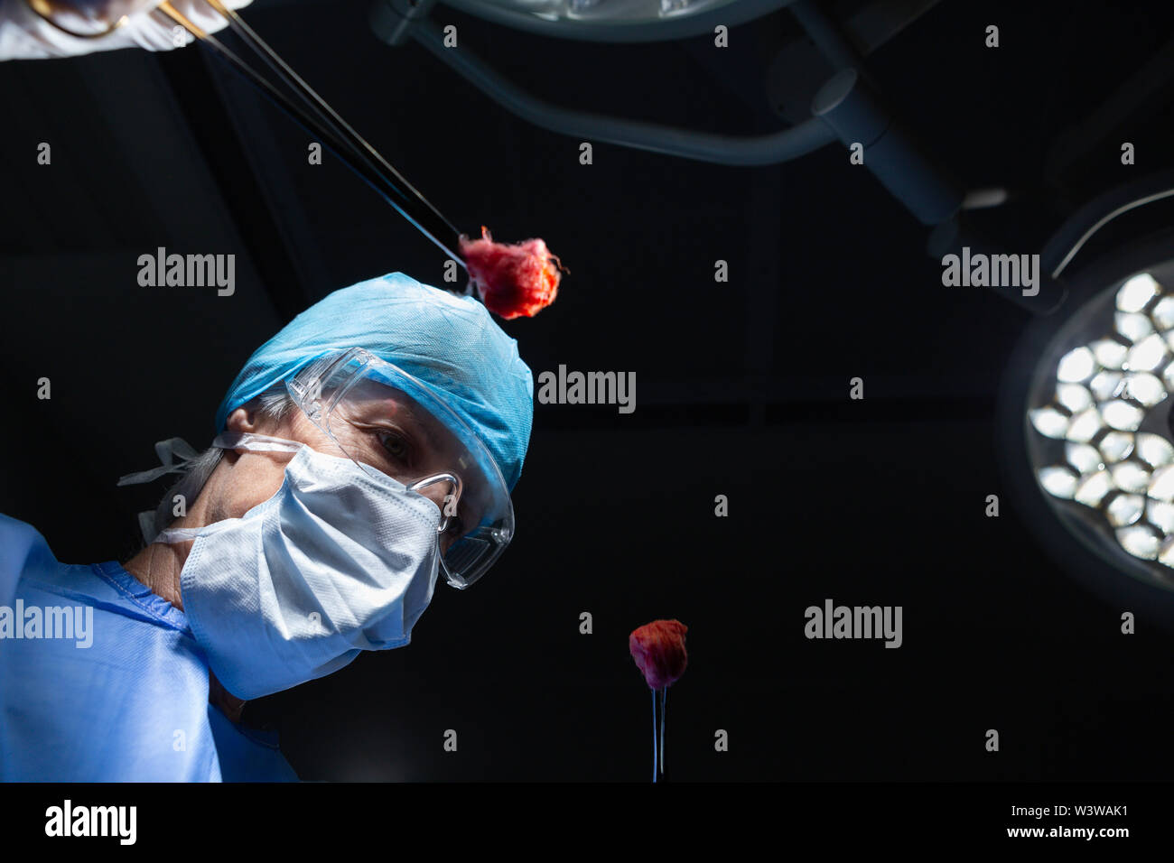 Male Surgeon performing operation in operation room Stock Photo - Alamy