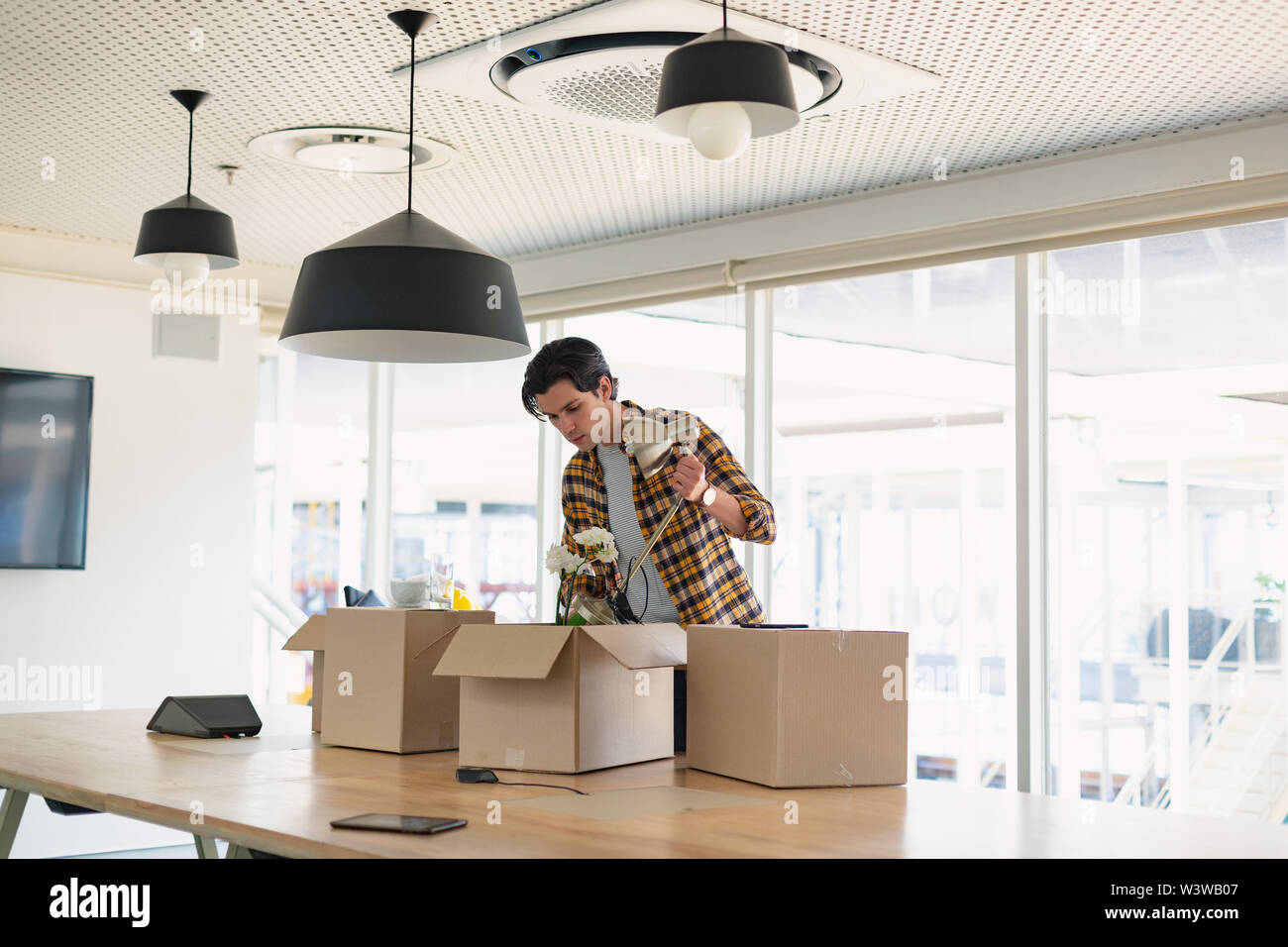 Male executive unpacking cardboard box in the conference room Stock ...