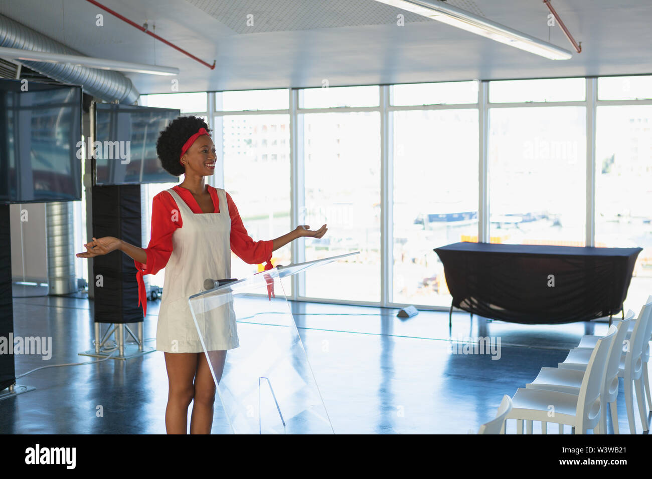 Female executive practicing her speech in the conference room at office ...