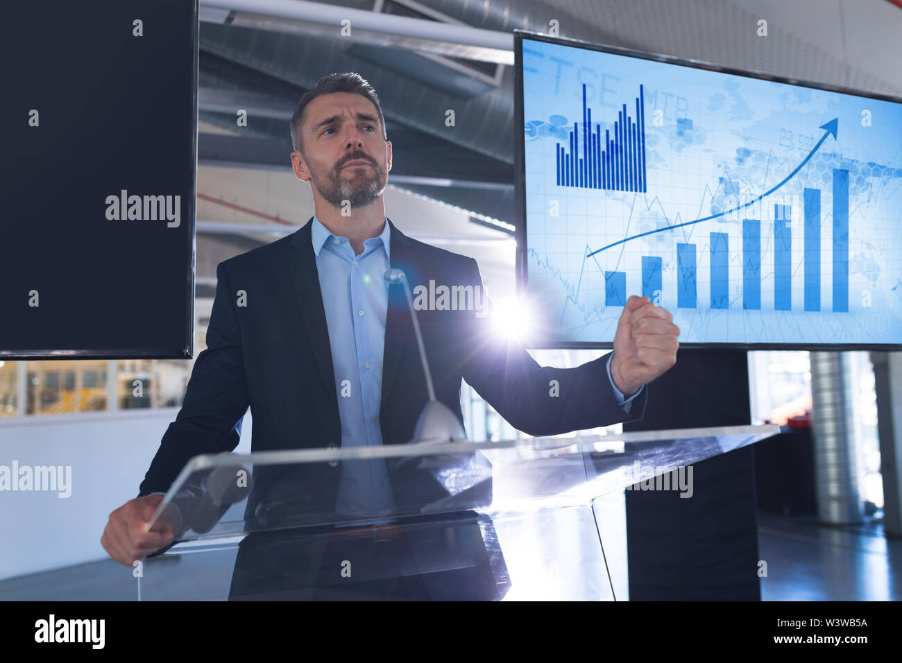 Male speaker speaking at podium in business seminar Stock Photo - Alamy