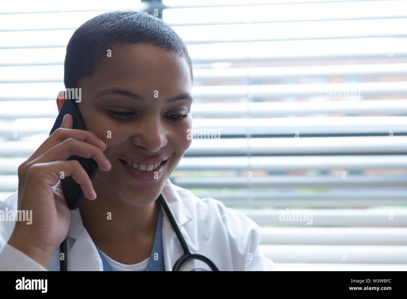 Female doctor talking on mobile phone in the hospital Stock Photo - Alamy