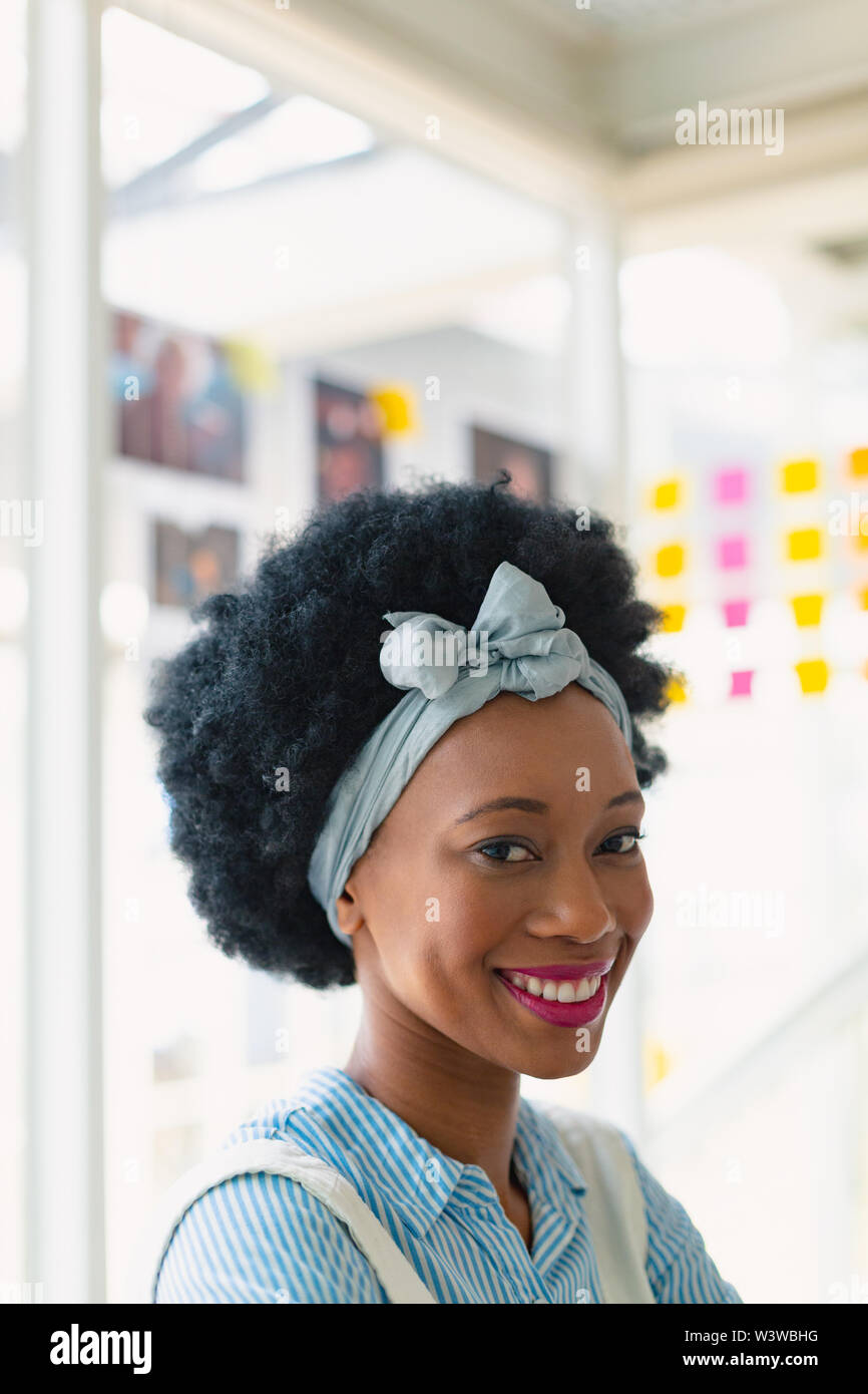 Female graphic designer smiling in office Stock Photo - Alamy