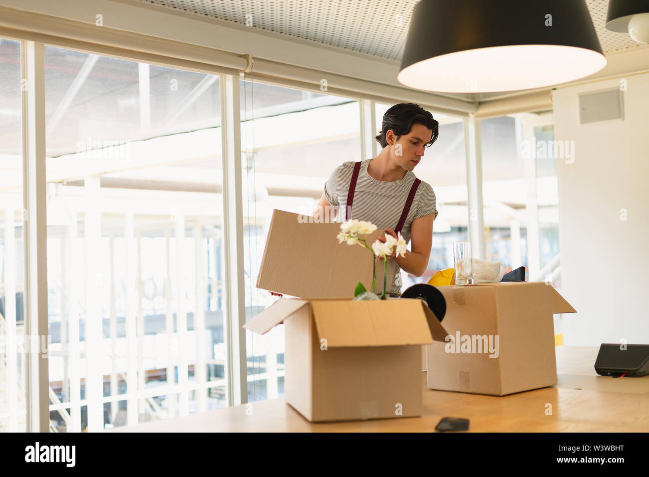 Male executive holding a cardboard box in the conference room Stock ...